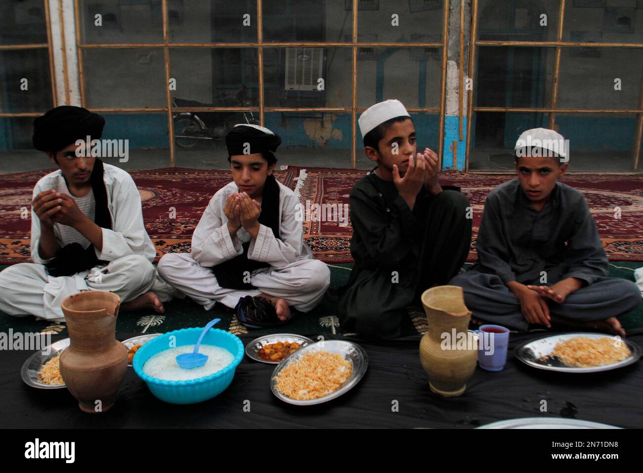 Afghan Muslim youths pray during the Muslim holy month of Ramadan at a ...