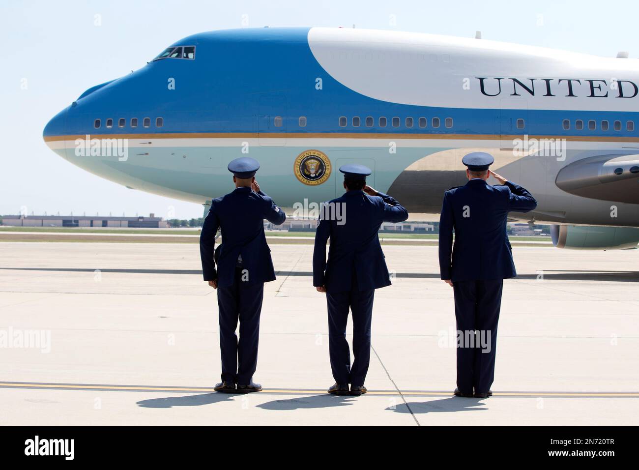 Air Force personnel salute as Air Force One, carrying President Barack ...