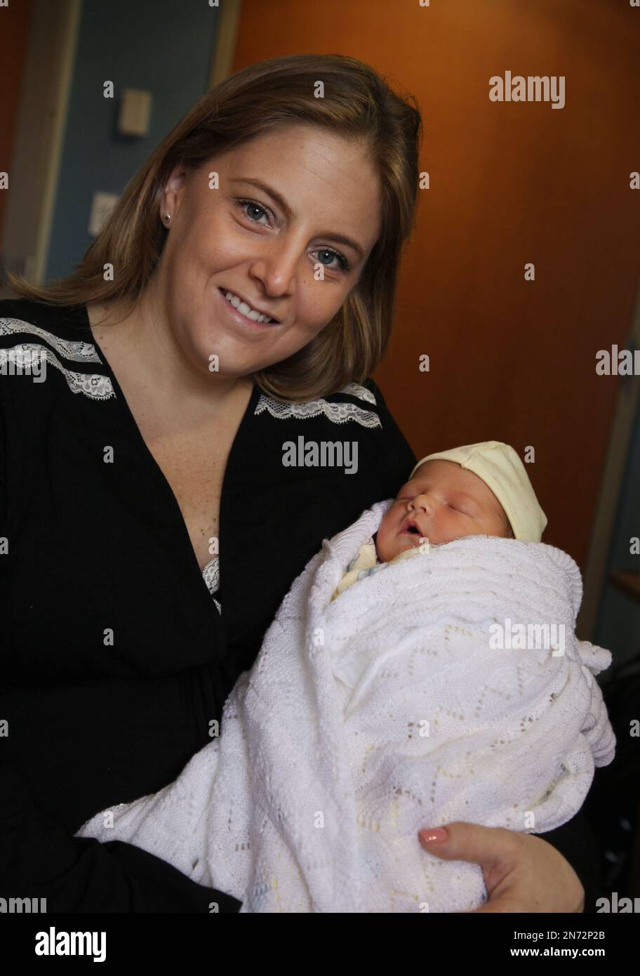 In this Wednesday, July 24, 2013 photo, Malu Millet holds her newborn ...