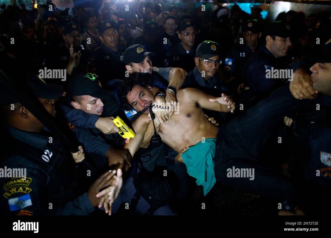 A police uses a taser stun gun on an anti-government protestor just ...