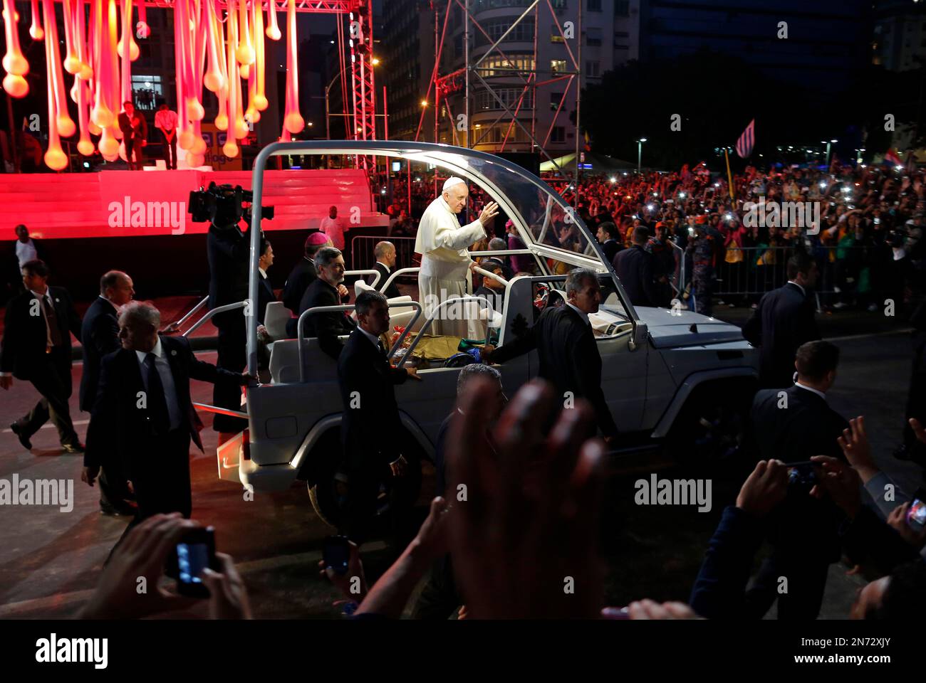 Pope Francis waves to pilgrims as he passes by the 13th station of the ...