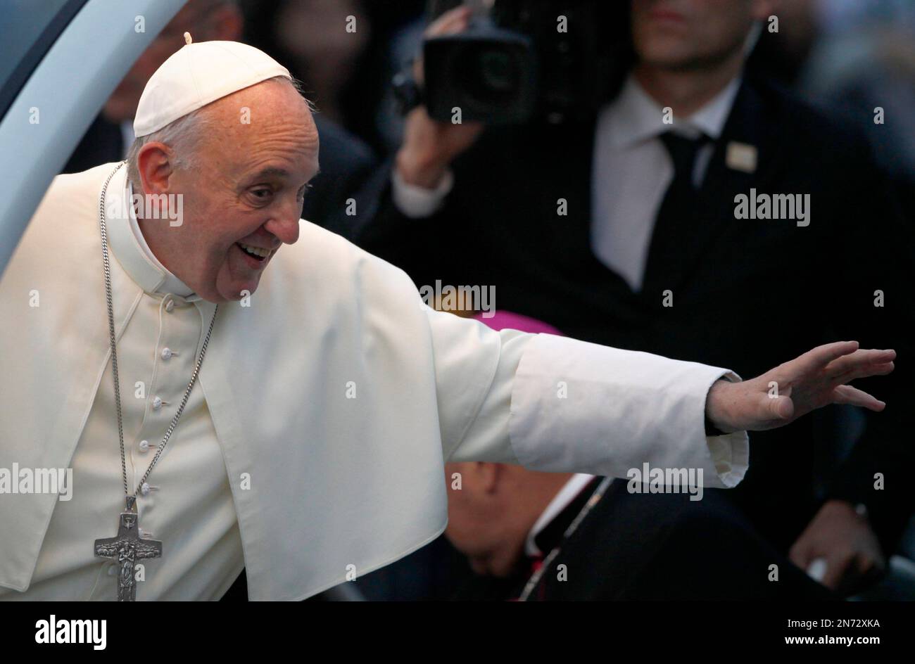 Pope Francis waves from his popemobile as he arrives for the Stations ...