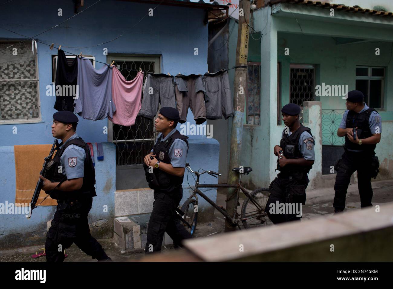 Policemen from the Pacifying Police Unit, or 'UPP', patrol in the ...