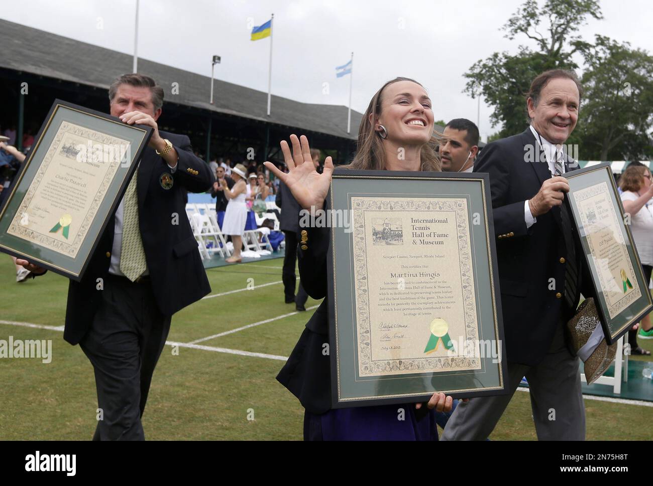 Tennis great Martina Hingis, of Switzerland, waves to fans as she and ...