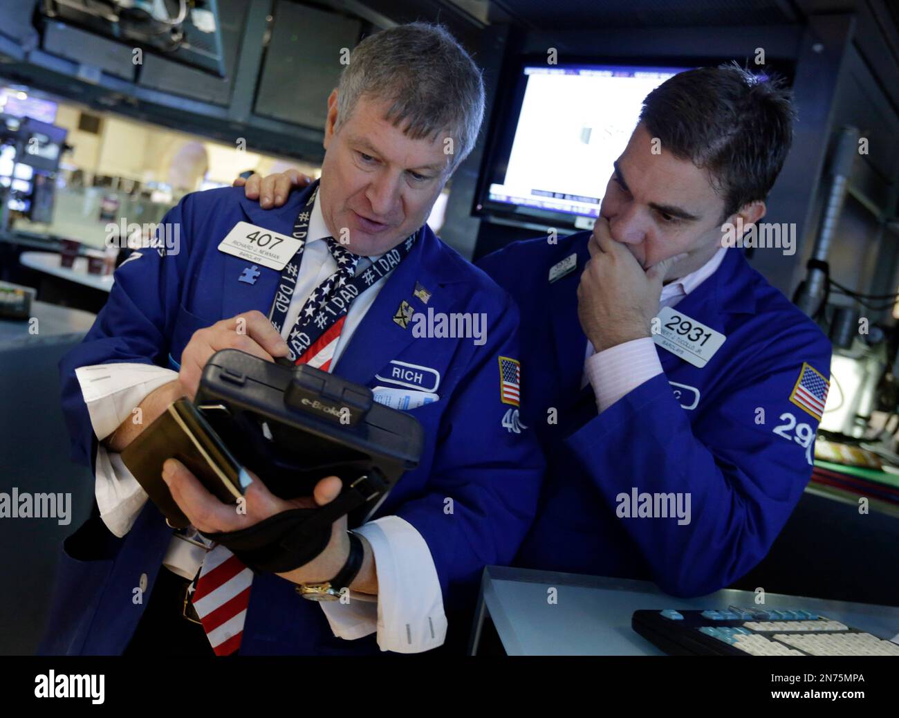 Trader Richard Newman, left, and specialist Robert Tuccillo confer on ...