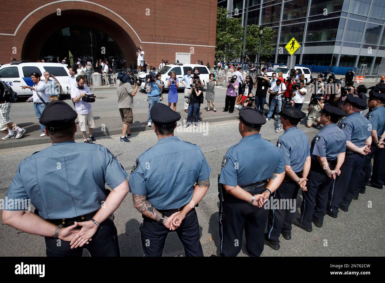 MIT police officers stand at attention outside the federal courthouse ...