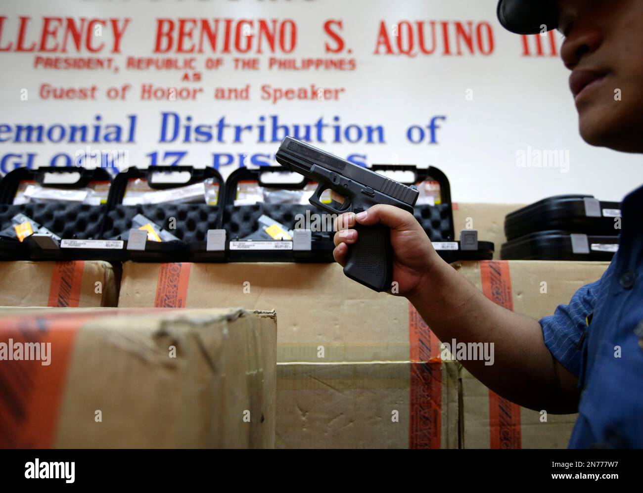 A Philippine police officer holds a brand new Glock 17 pistol to be ...