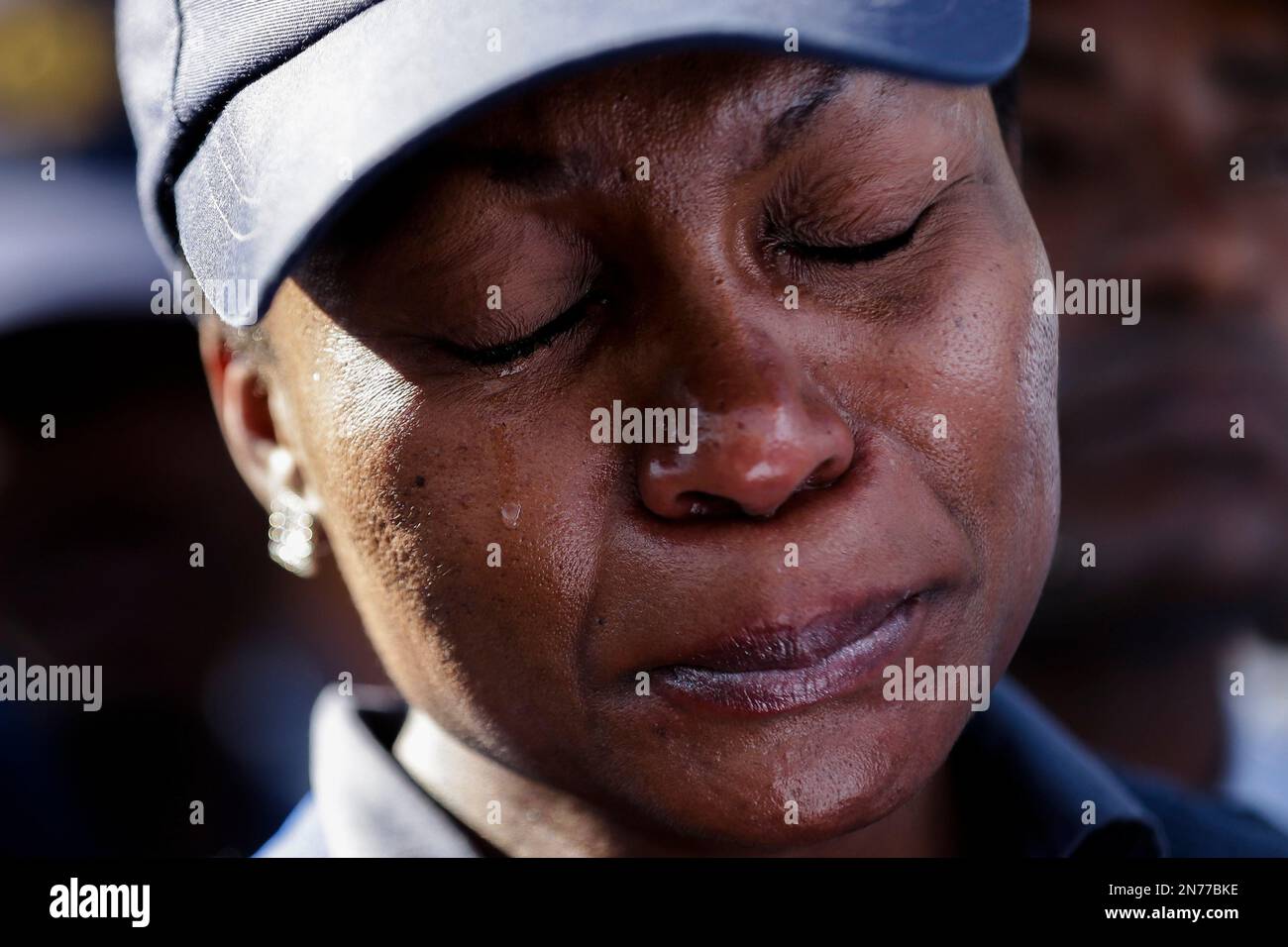 Constable Maureen Mailula weeps during prayers from police officers in ...