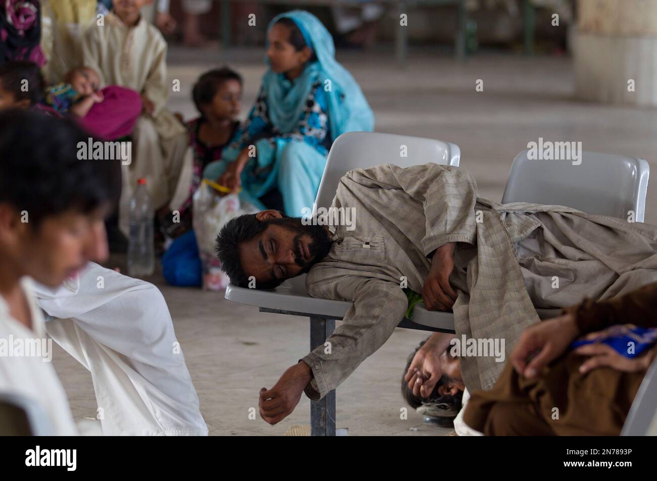 Pakistani drug addicts lie down in the waiting lounge of a public ...