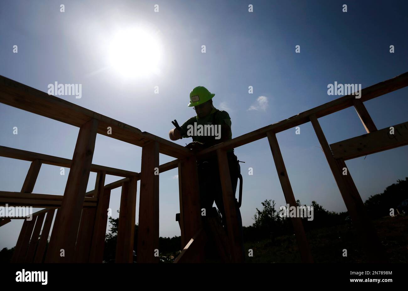 Jim Fry of Mansfield, Texas, drives a nail into a frame as he helps ...
