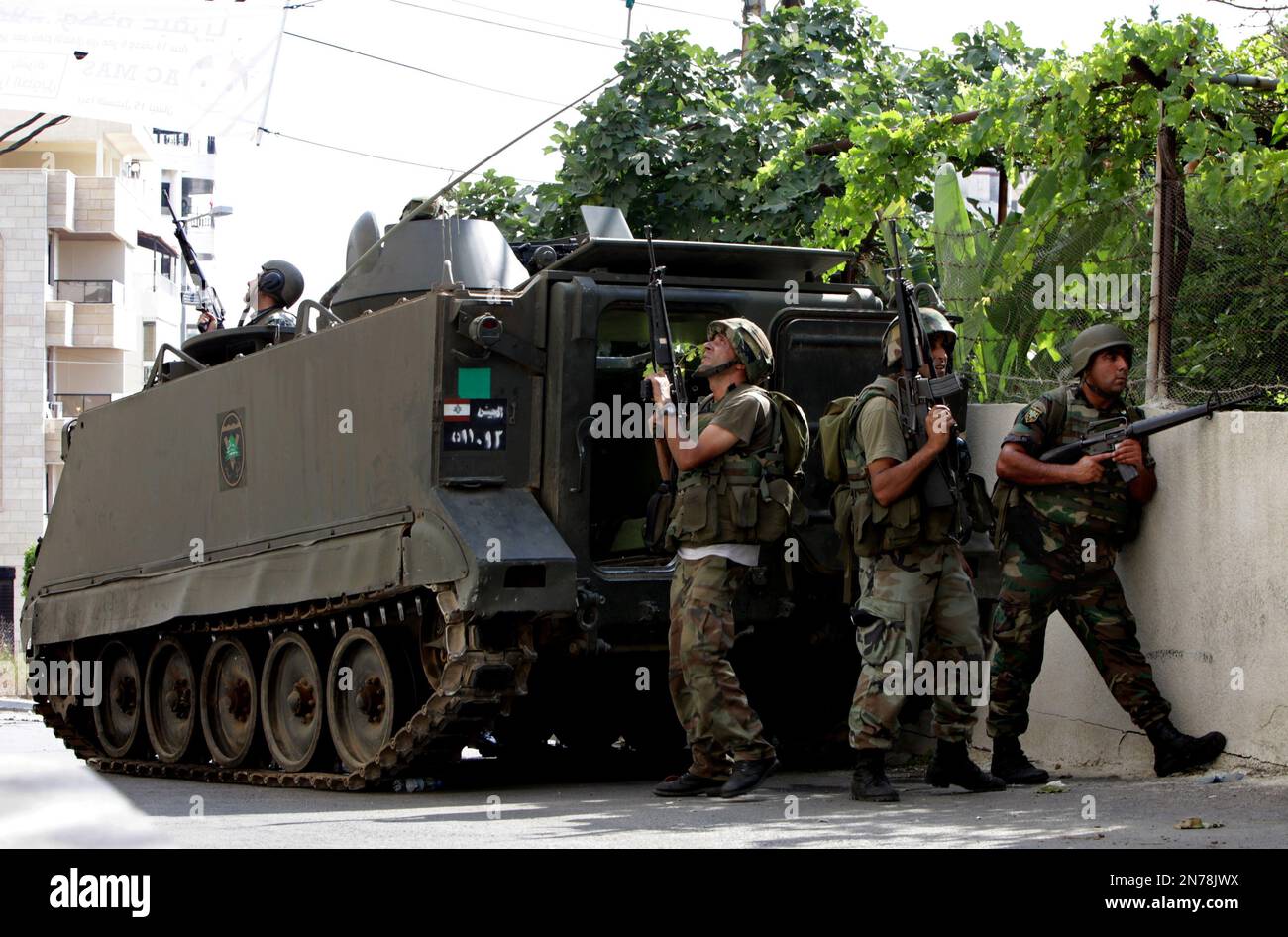 Lebanese army soldiers take their positions as they raid homes to ...