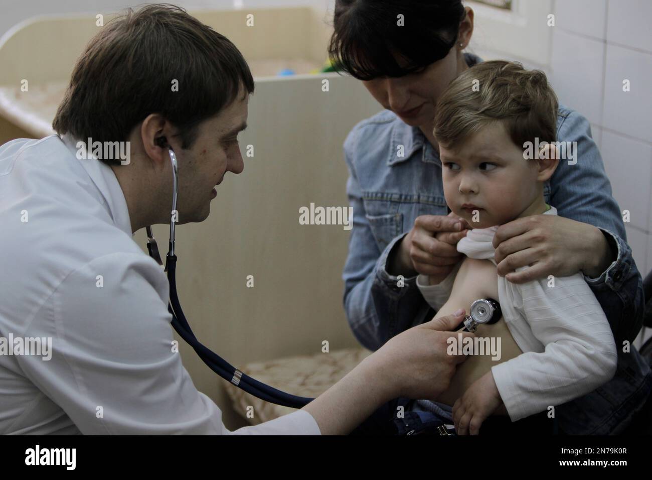 In this Monday, April 23, 2013 photo pediatrician Fyodor Lapiy examines ...