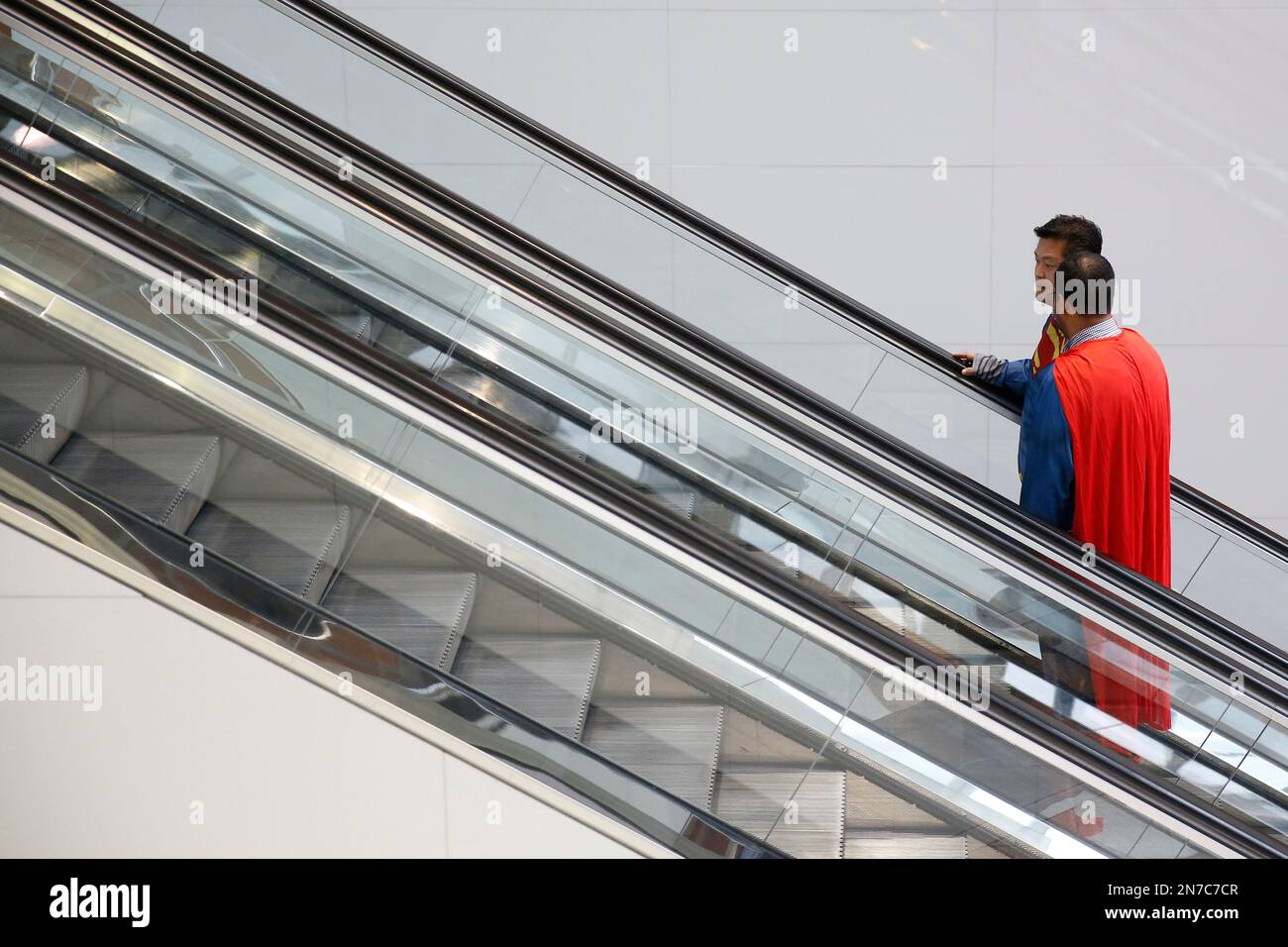 Sears employees Byung Kang and Naveen Seshadri ride the escalator to ...