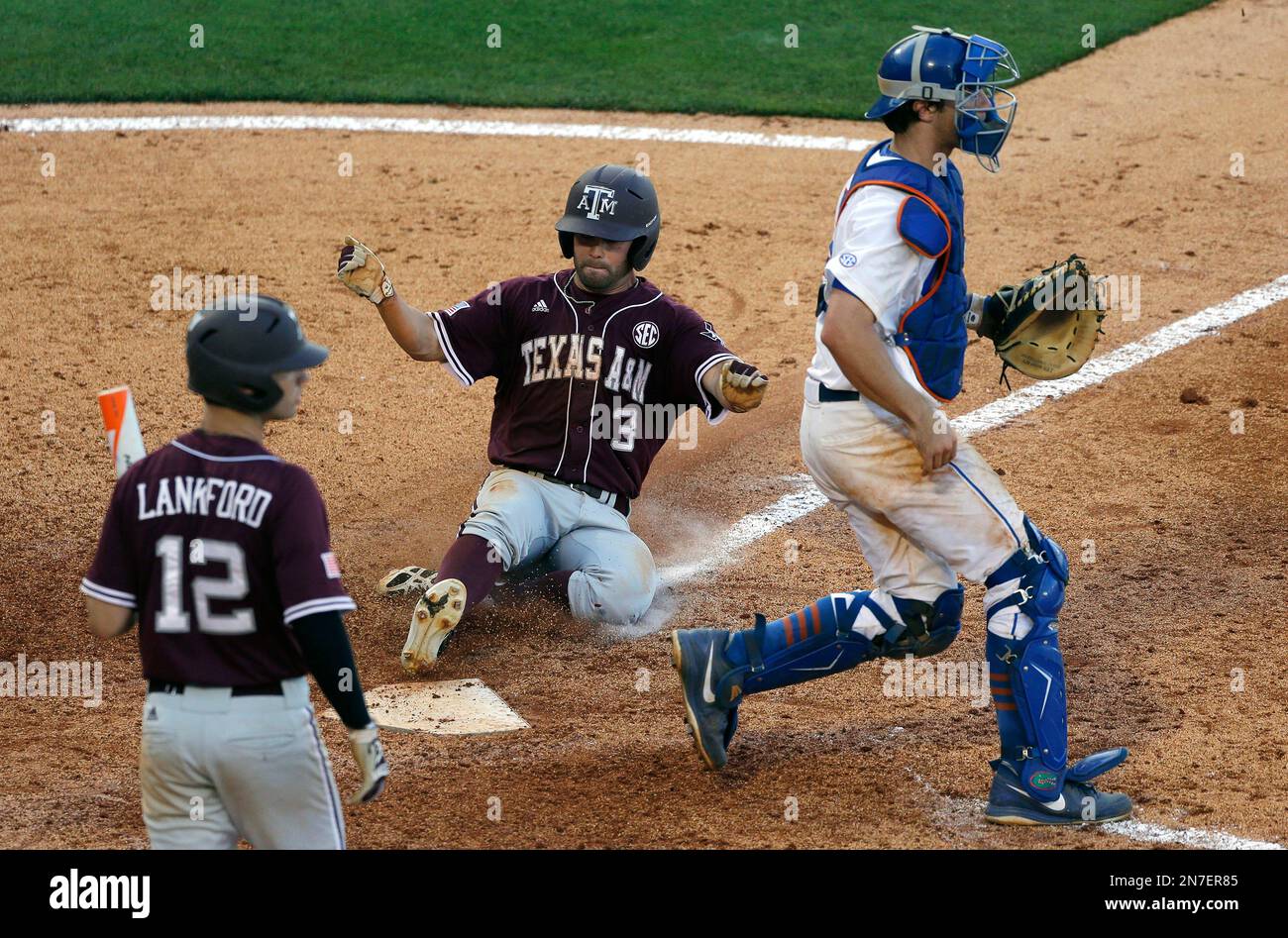 Texas A&M's Jace Statum (3) steals home as Florida catcher Taylor ...