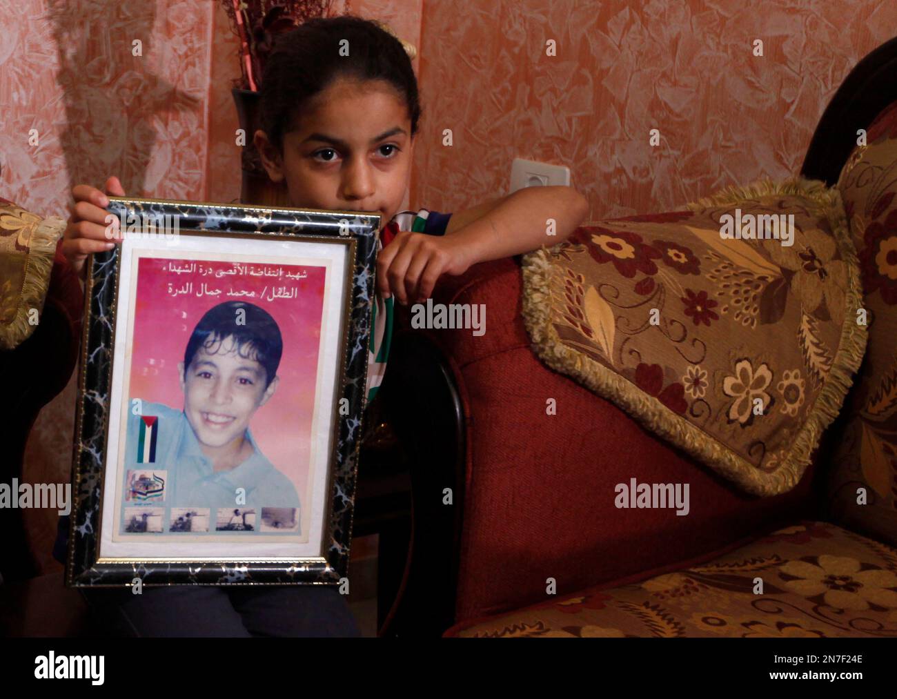 Baraa al-Dura, sister of Mohammed al-Dura poses with a picture of ...