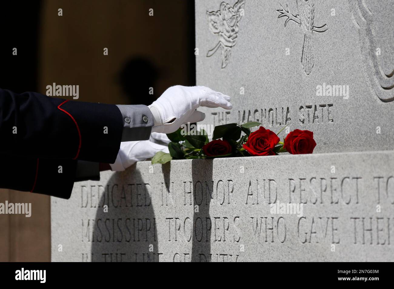 Mississippi Highway Patrol Honor Guard Trooper Kevin Burnett places a ...