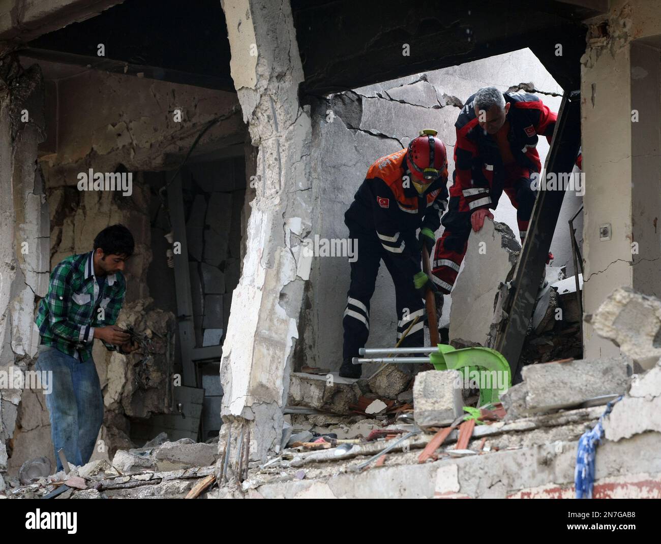 Police forensic officers and Umit Celik, left, search for the body of ...