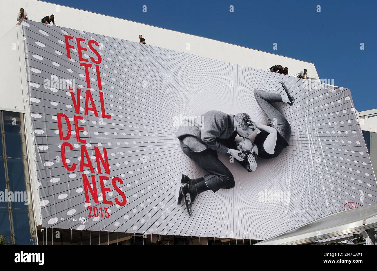 Workers sets up a giant 66th Cannes Film Festival official poster at ...