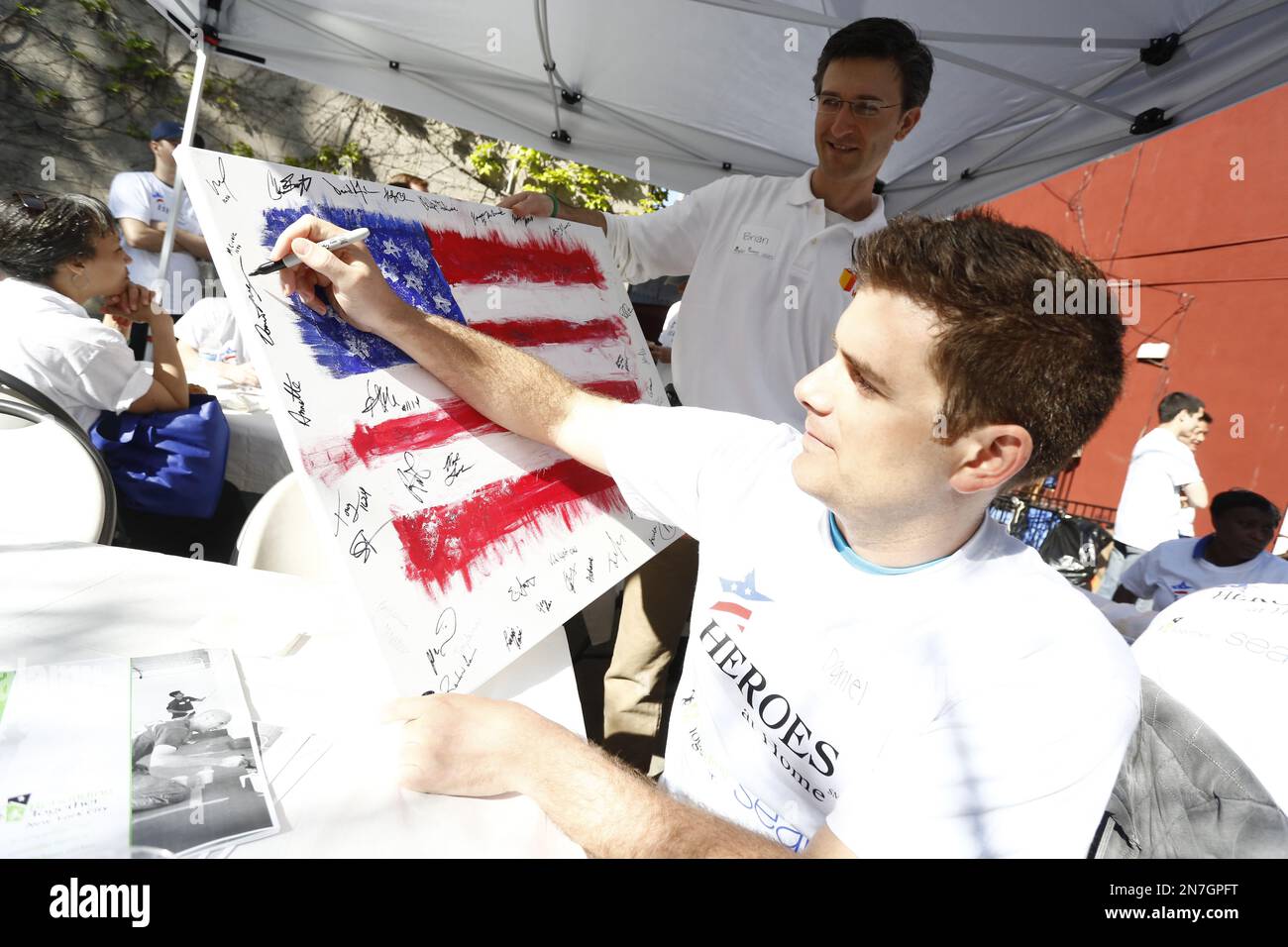 Sears employees sign a piece of artwork which will be given to a ...