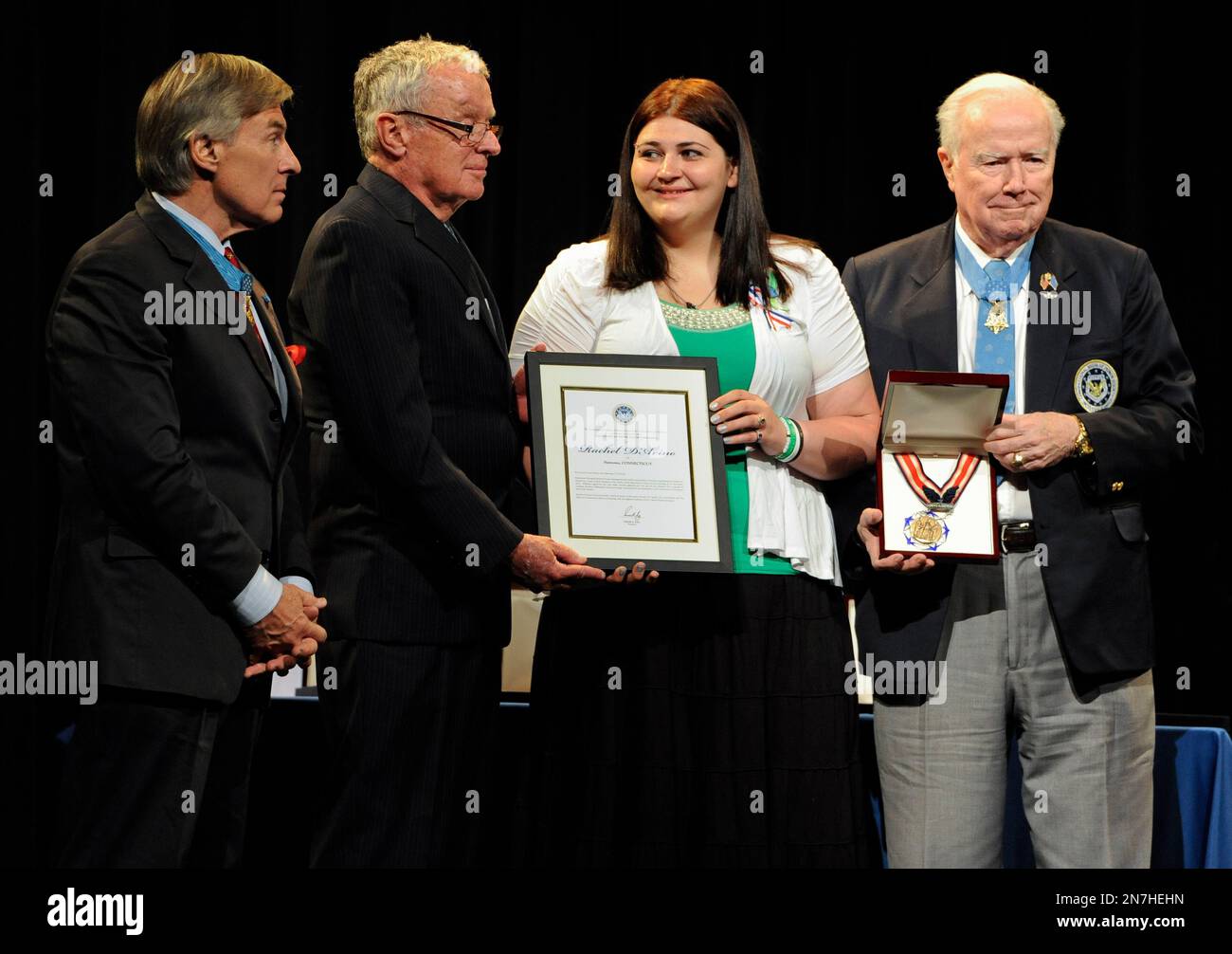 Hannah D'Avino, second from right, accepts the citizen honor from the ...