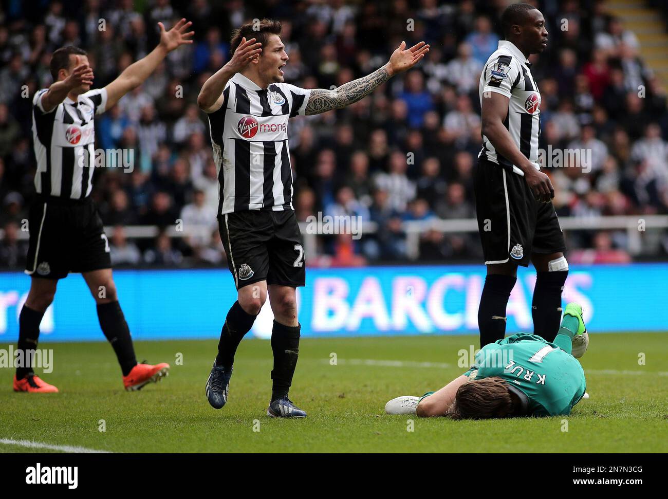 Newcastle United's goalkeeper Tim Krul, bottom, is on the ground ...