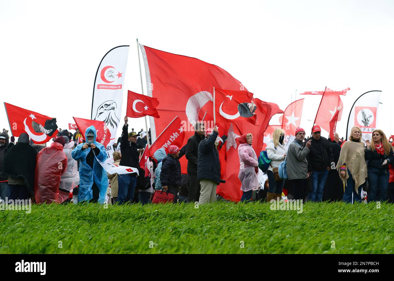 Thousands of Turks, holding national flags and posters of Turkey's ...