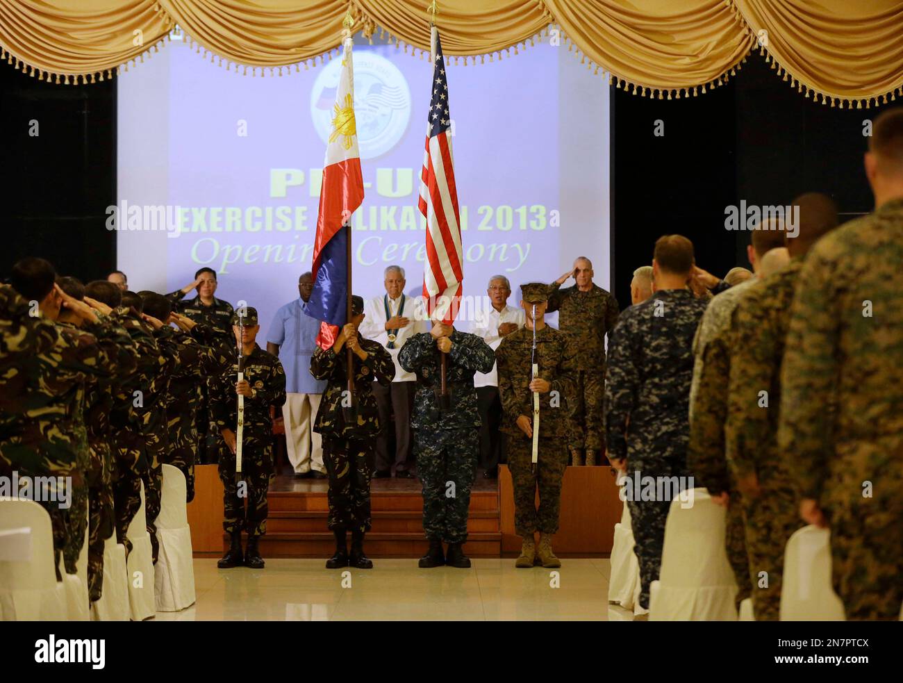 Philippine and US military officers salute as their respective ...