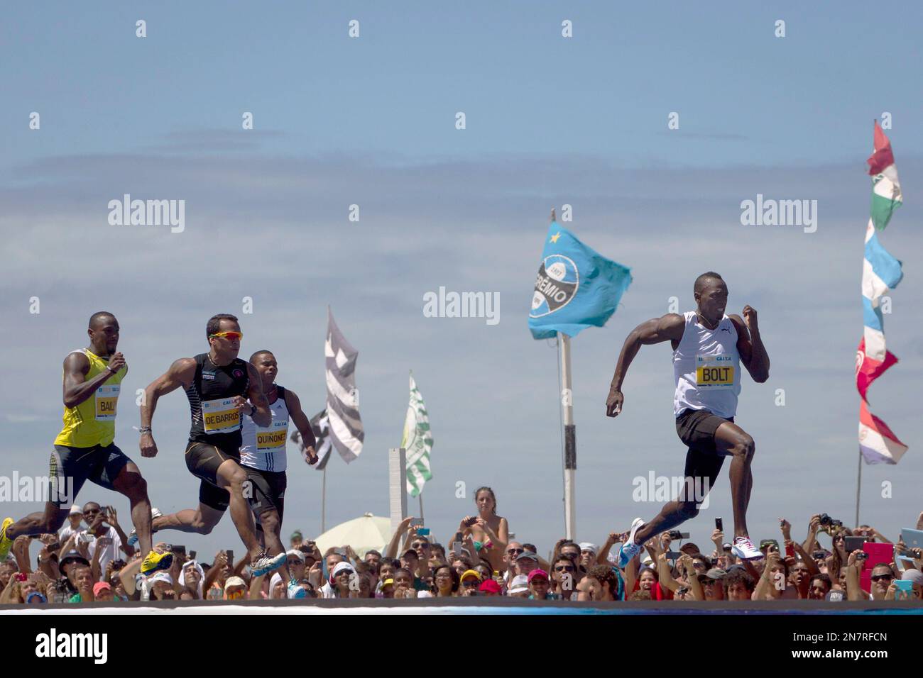 Jamaican Olympic gold medallist Usain Bolt, right, runs to win the ...