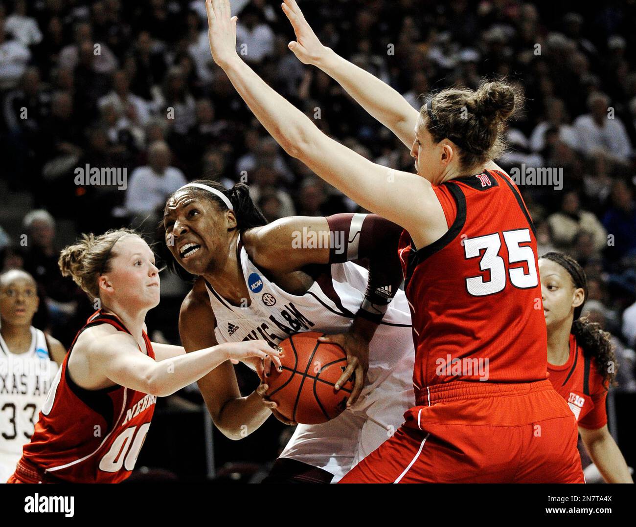 Texas A&M's Kelsey Bone, center, tries to get to the basket between ...