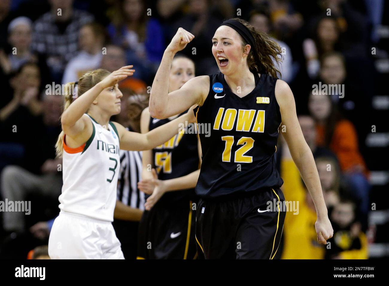Iowa center Morgan Johnson (12) reacts in front of Miami guard Stefanie ...