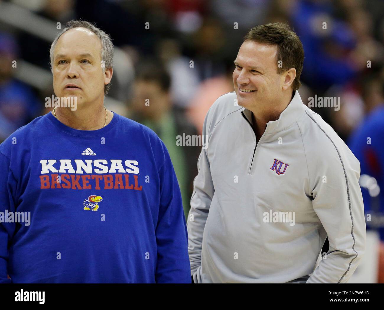 Kansas coach Bill Self, right, peeks around assistant coach Doc Sadler ...