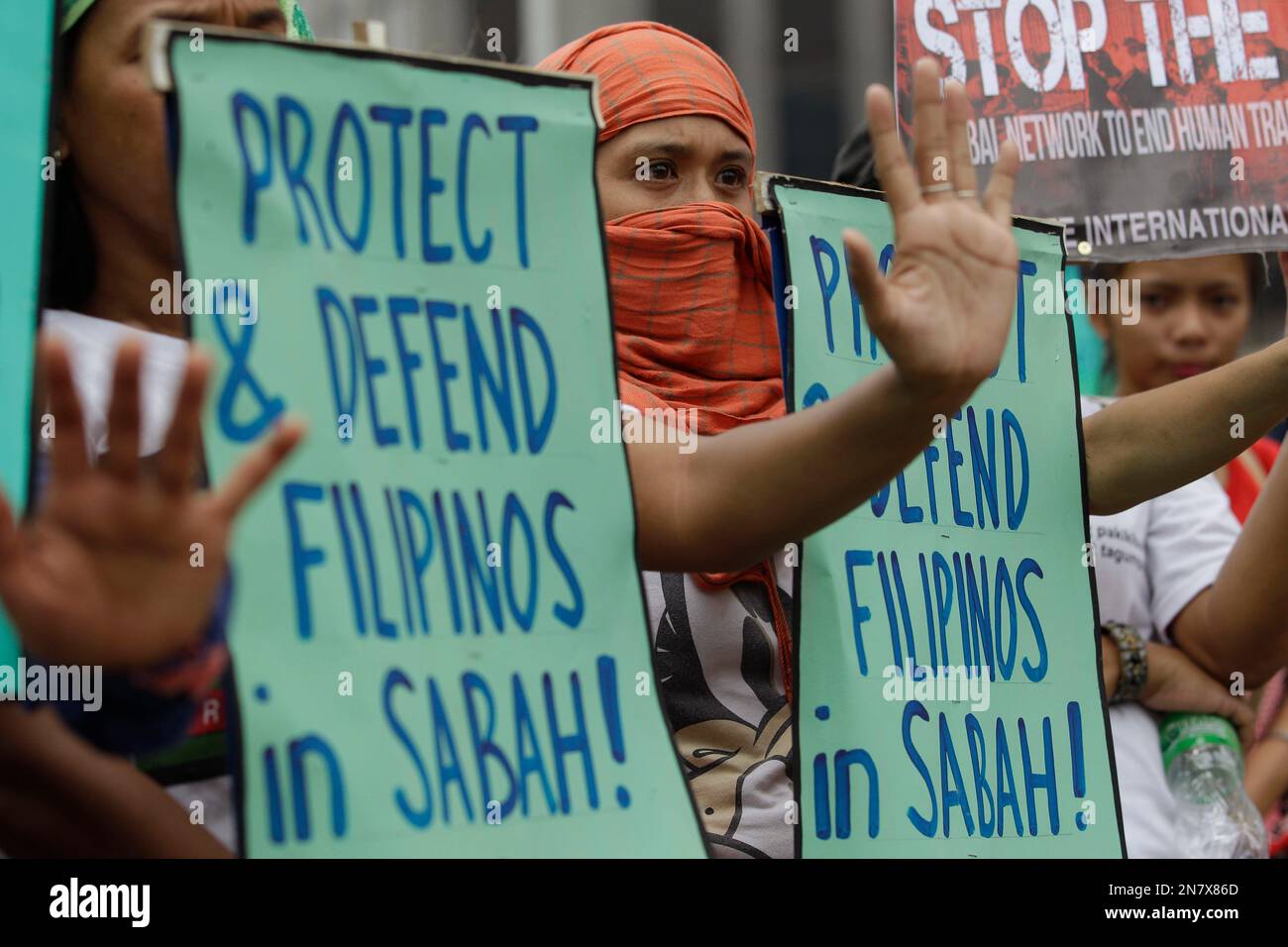 Filipino activists raise their hands during a rally in Manila ...