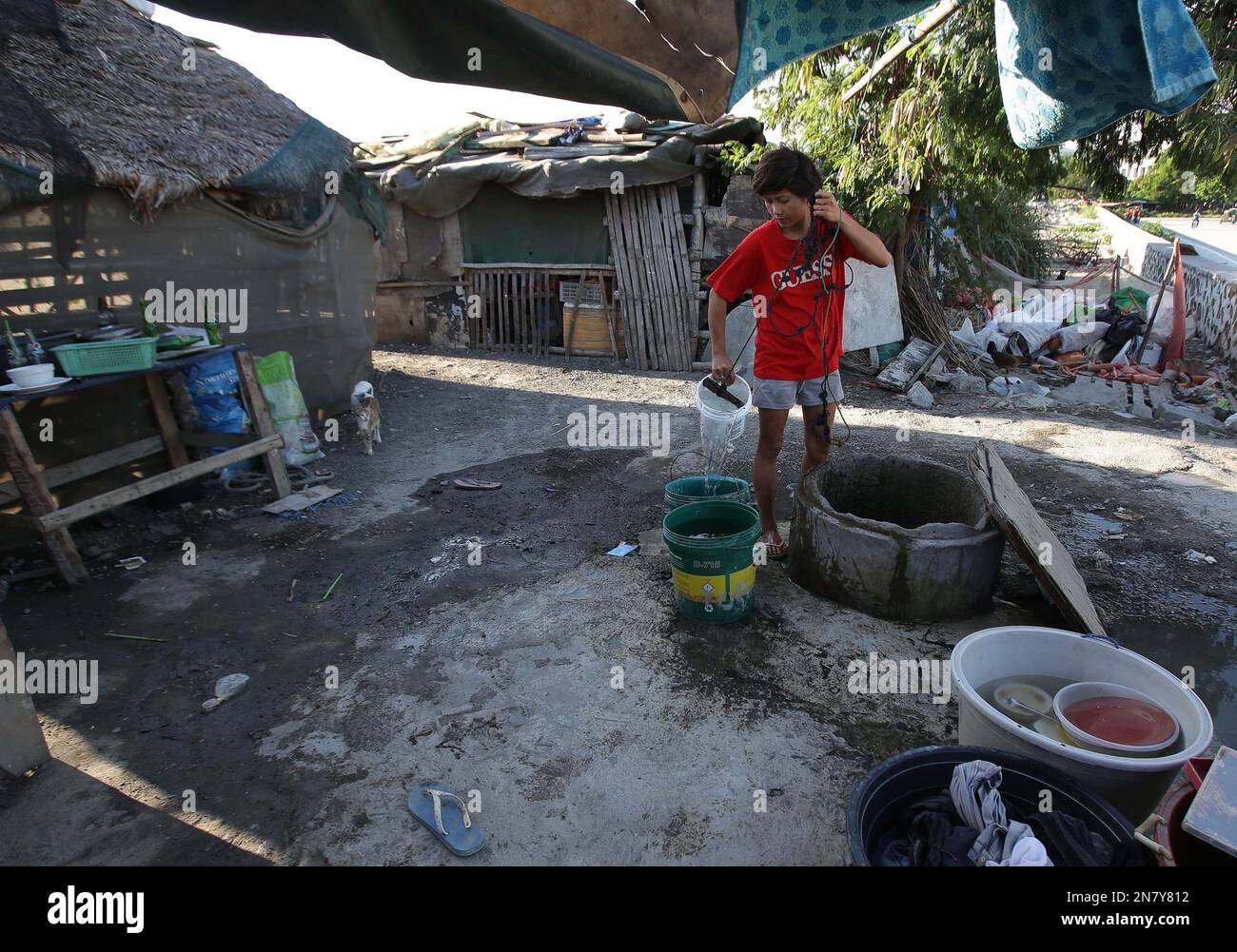 In this March 12, 2013 photo, a Filipino woman fetches water from a ...