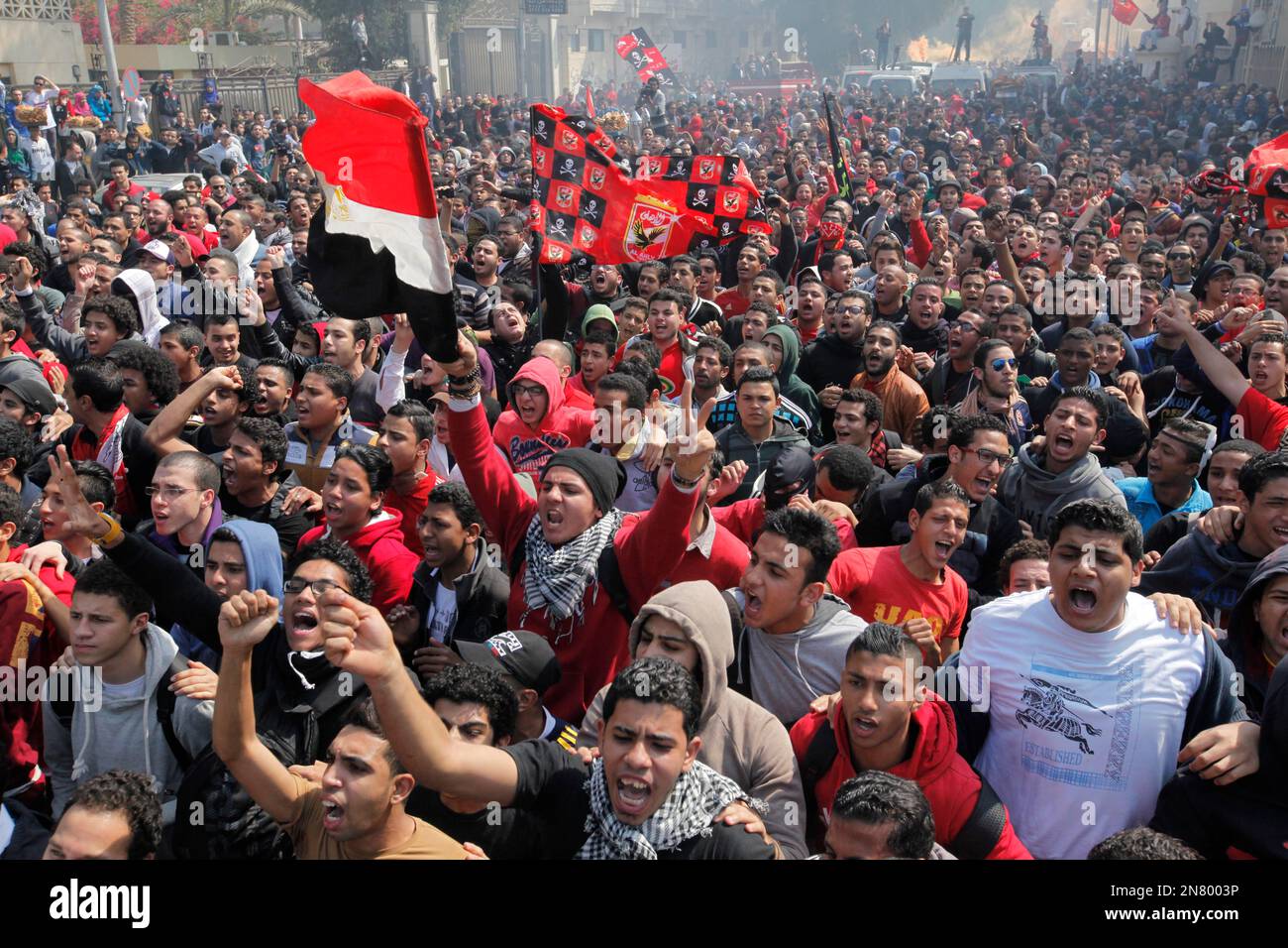 Egyptian soccer fans of Al-Ahly club wave national and Al-Ahly flags as ...