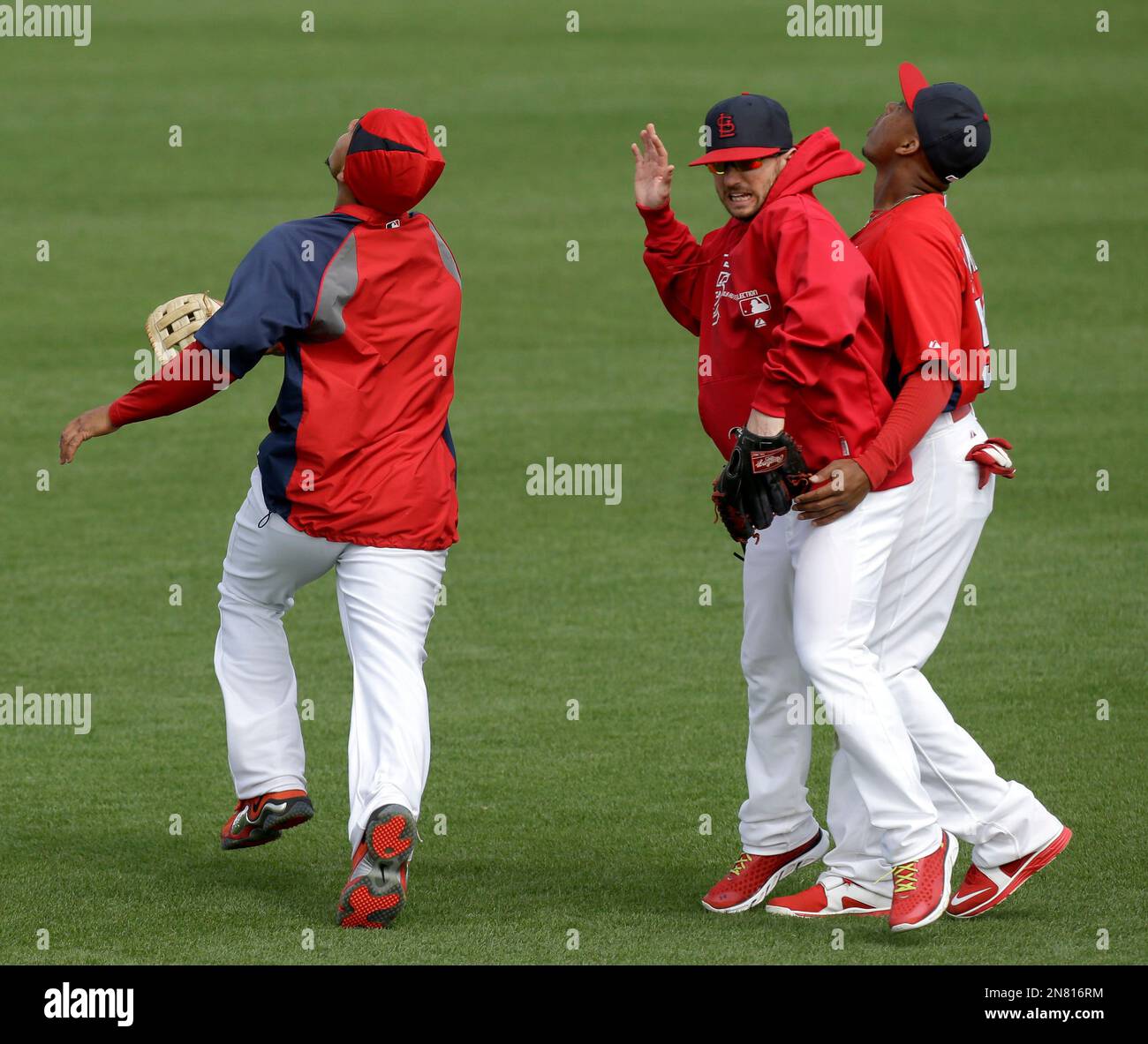 St. Louis Cardinals center fielder Jon Jay, left, chases a fly ball ...
