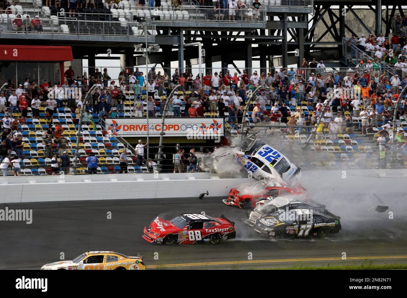 Kyle Larson (32) goes airborne into the catch fence in a multi-car crash including Dale ...