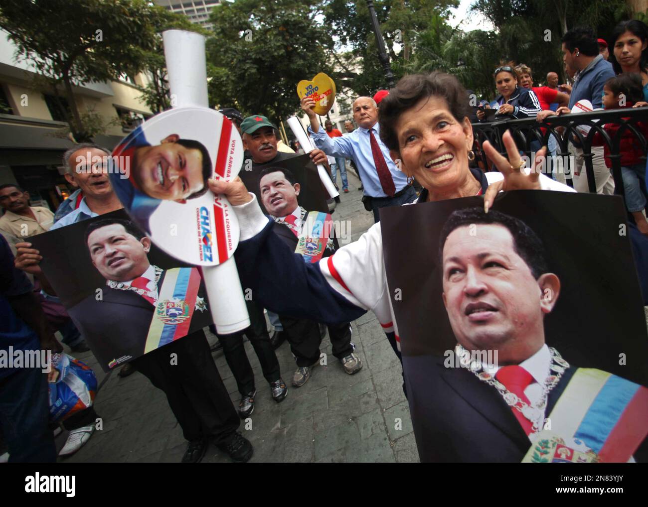 A woman reacts to the camera as supporters holding pictures gather in ...