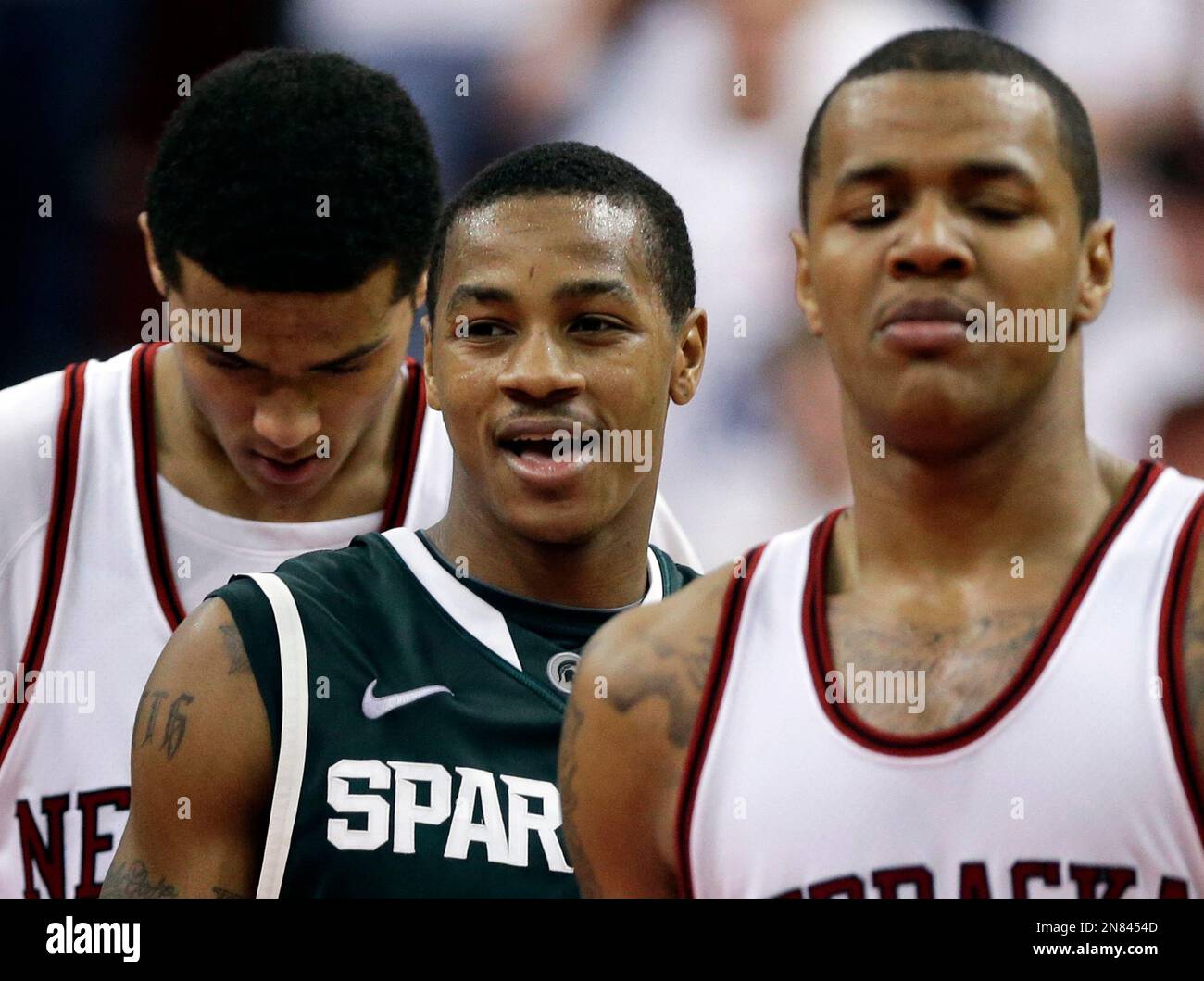 Michigan State's Keith Appling, center, smiles as he goes to the free ...