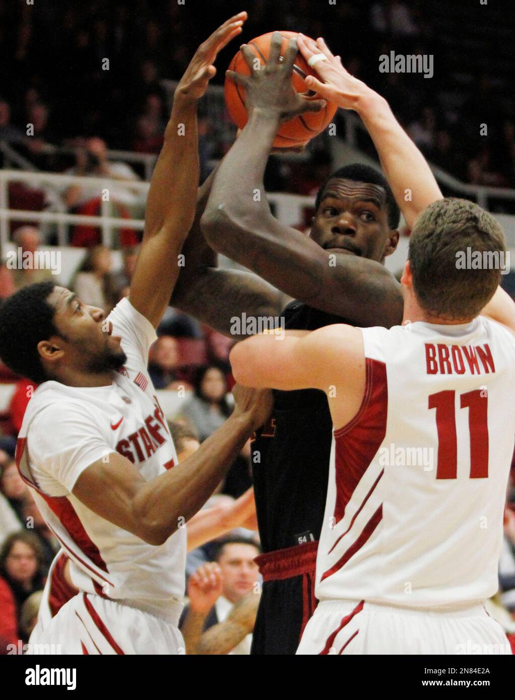 Southern California's Dewayne Dedmon, center, looks to pass as Stanford ...