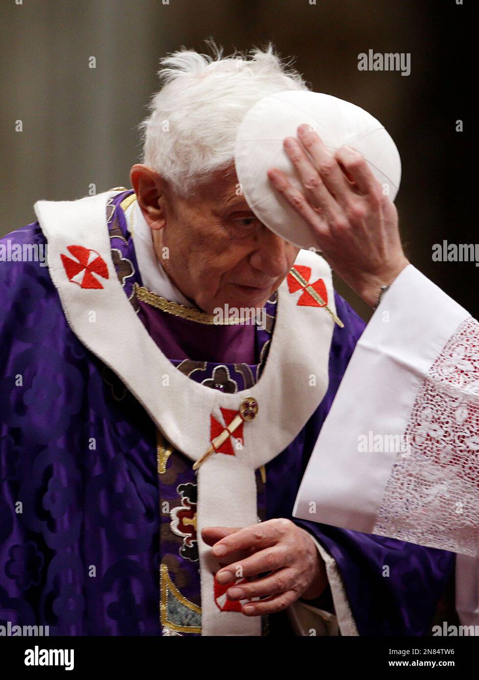 Bishop Guido Marini holds Pope Benedict XVI's skull cap during the Ash ...