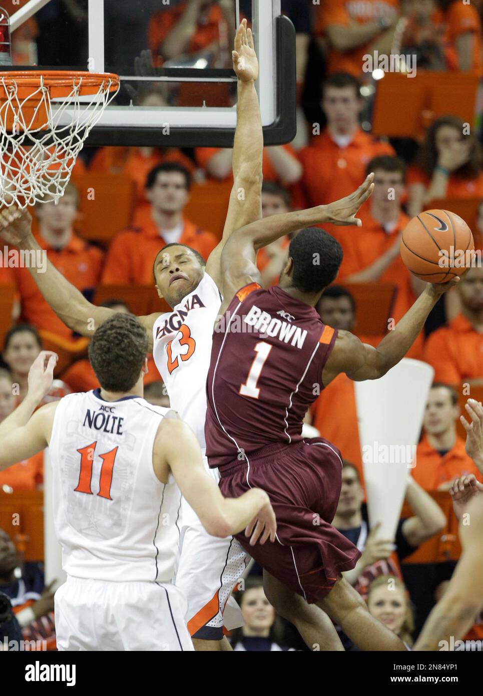 Virginia Tech guard Robert Brown (1) drives to the basket as Virginia forward Evan Nolte (11 ...