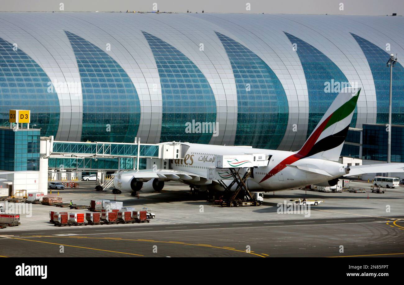 An Emirates plane is parked at the new Concourse A of Dubai airport in ...