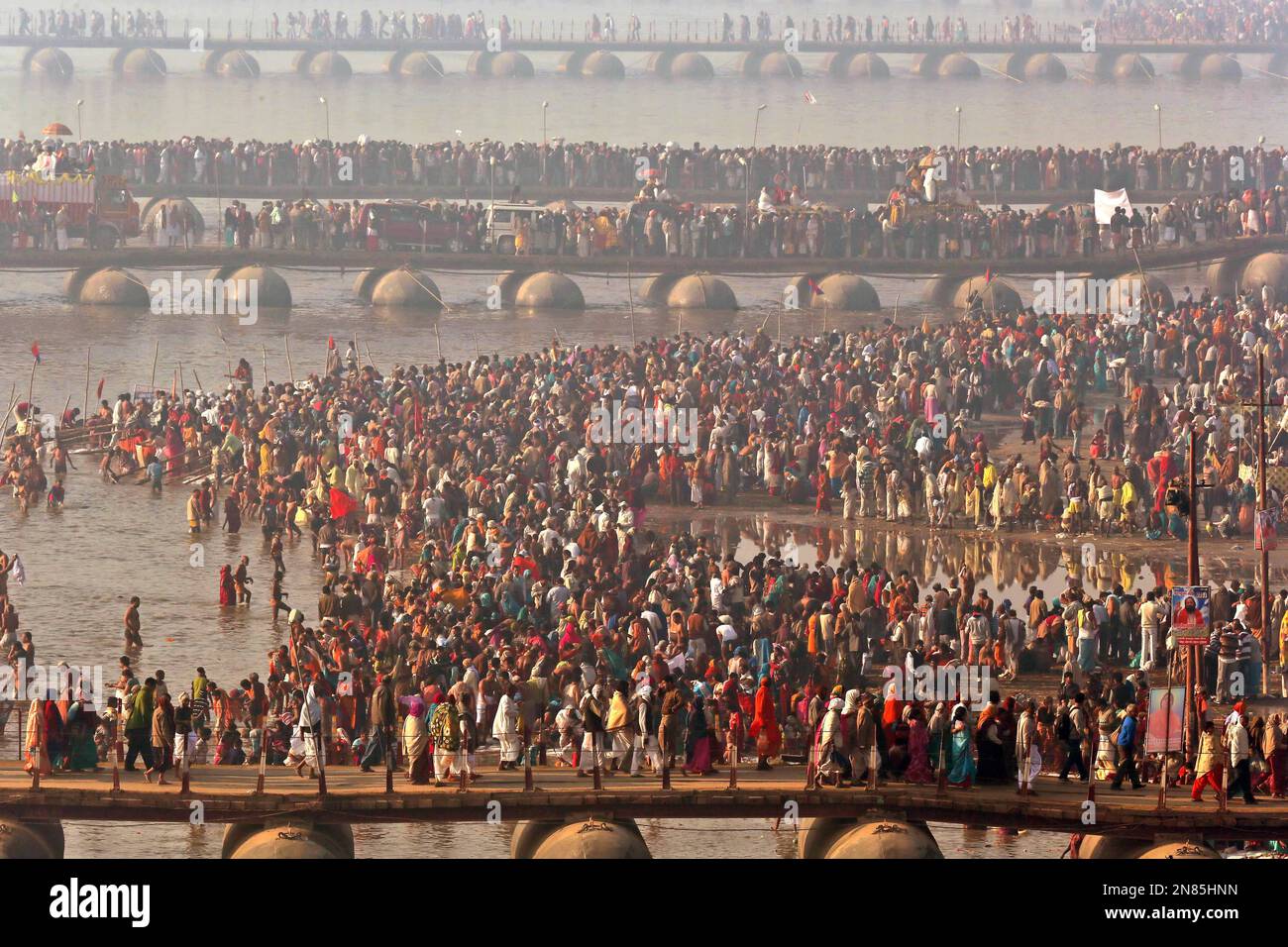 Hindu devotees walk across pontoon bridges to take a holy dip at Sangam ...