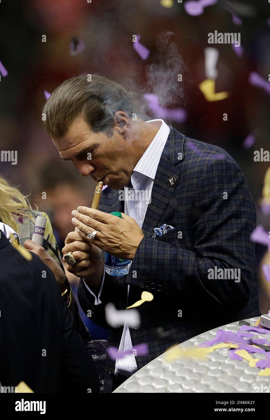 Baltimore Ravens owner Stephen J. Bisciotti lights a cigar after the ...