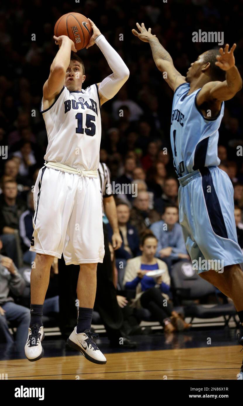 Butler guard Rotnei Clarke, left, shoots over Rhode Island guard Mike ...