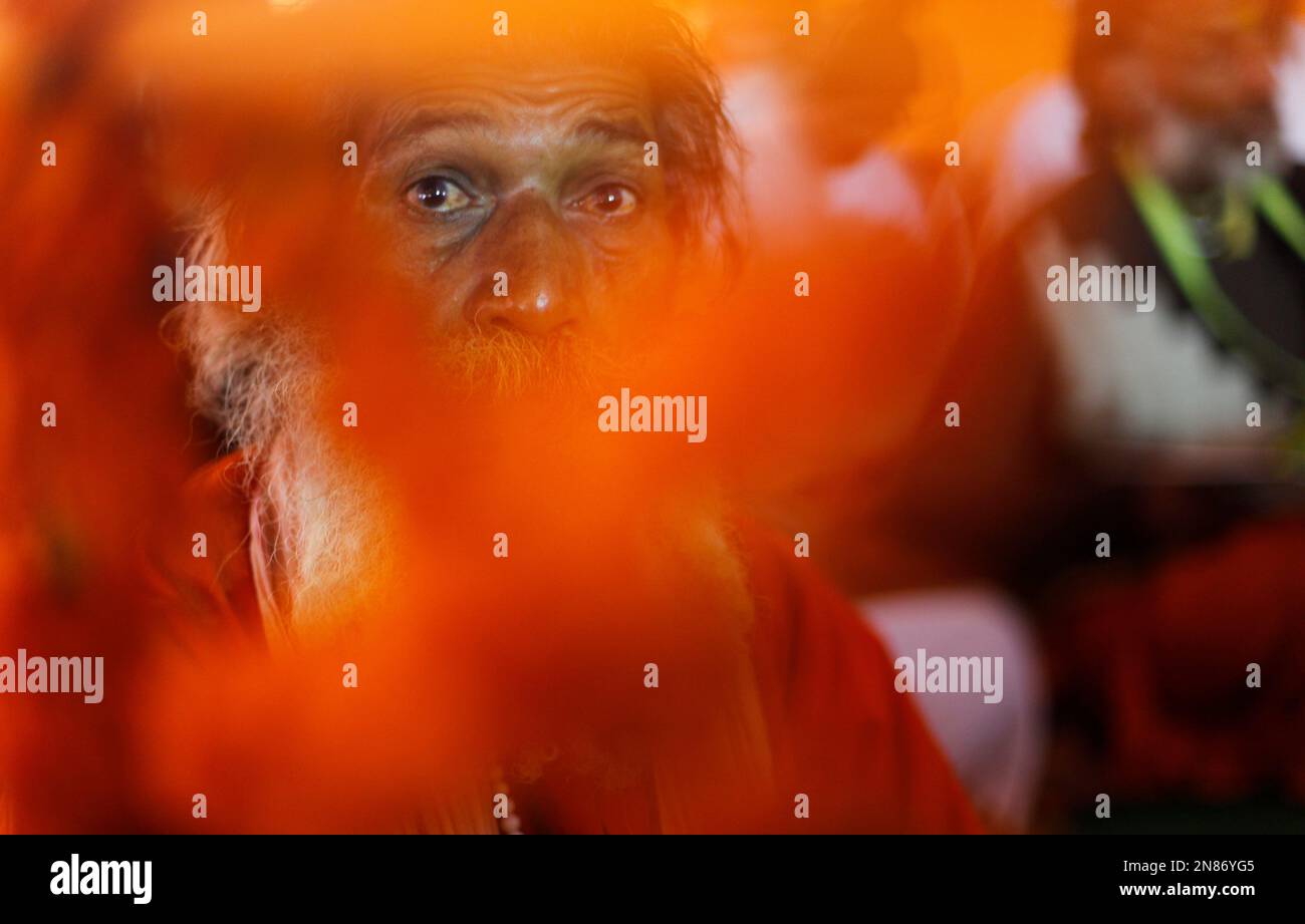 An Indian Hindu devotee listens to spiritual leader Swami Sri ...