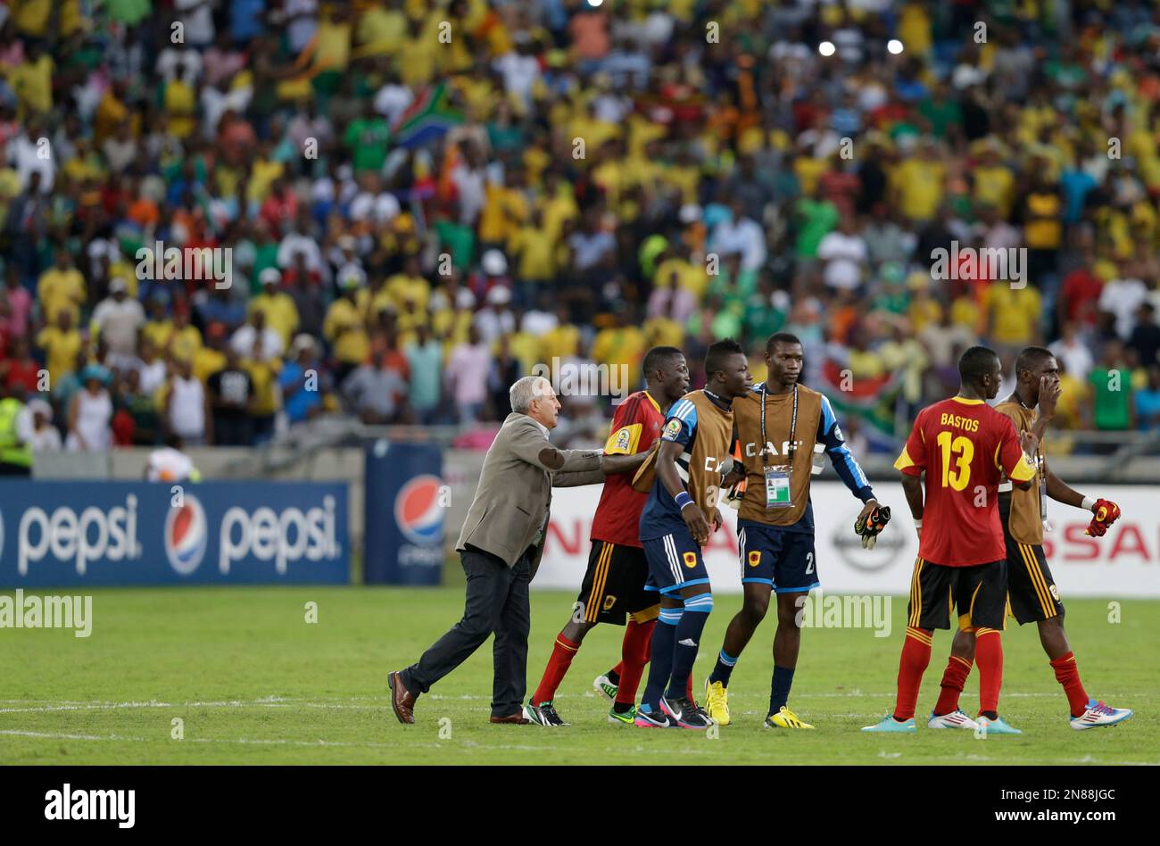 Angola's head coach Gustavo Ferrin, left, hustles his players off the ...