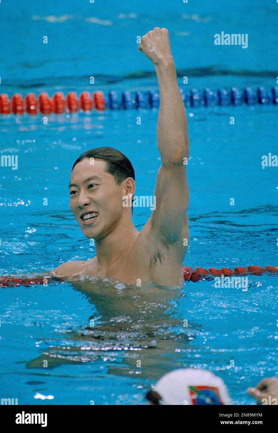 Daichi Suzuki of Japan raises his arm after he won the Olympic men's swimming 100-meter ...