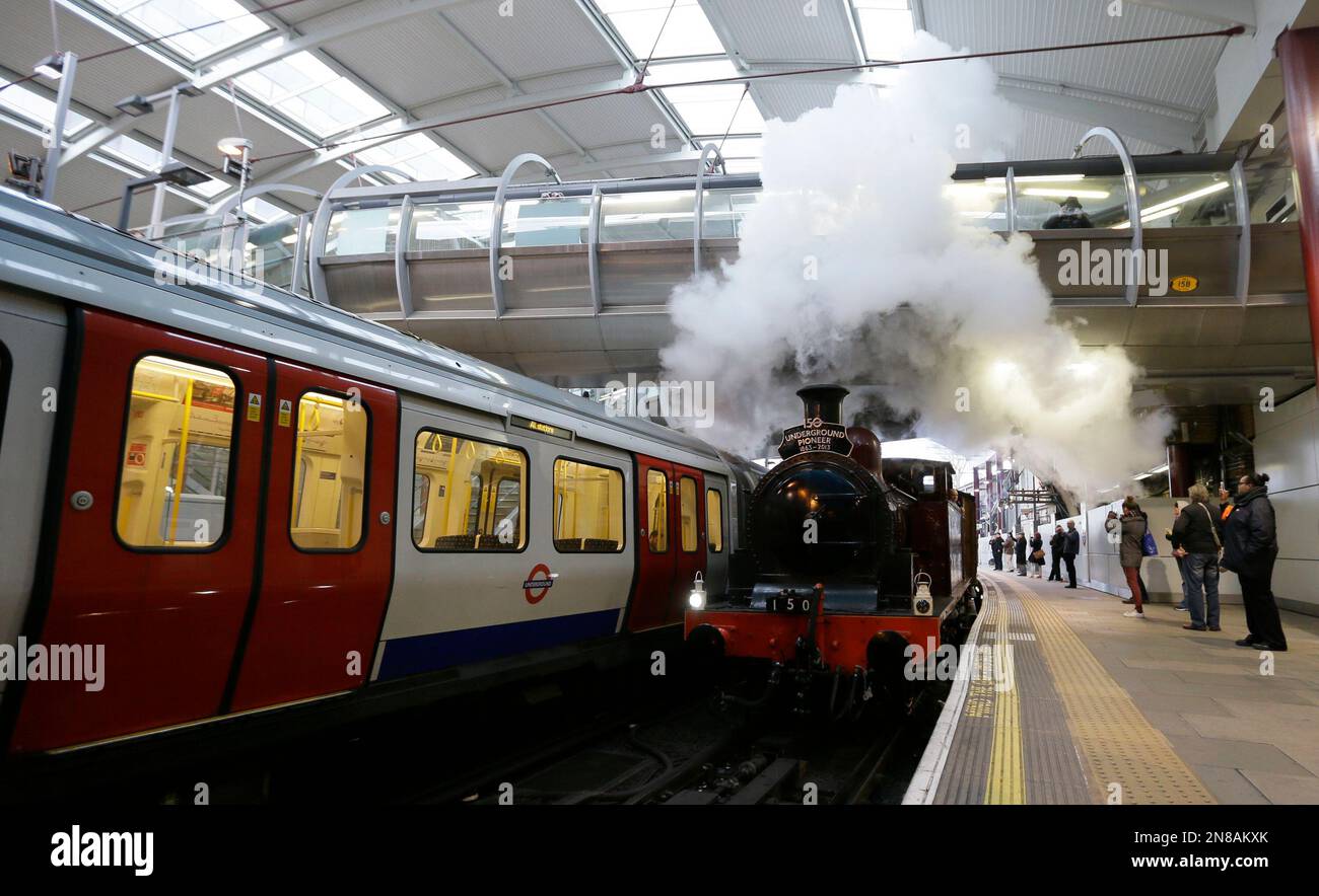 Metropolitan 1, a restored steam train built in 1898, passes a modern ...