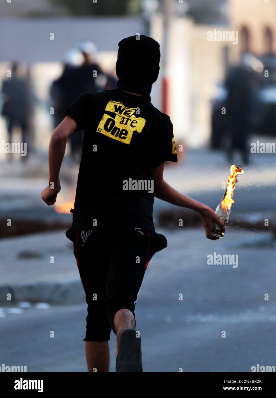 A Bahraini anti-government protester prepares to throw a petrol bomb at ...